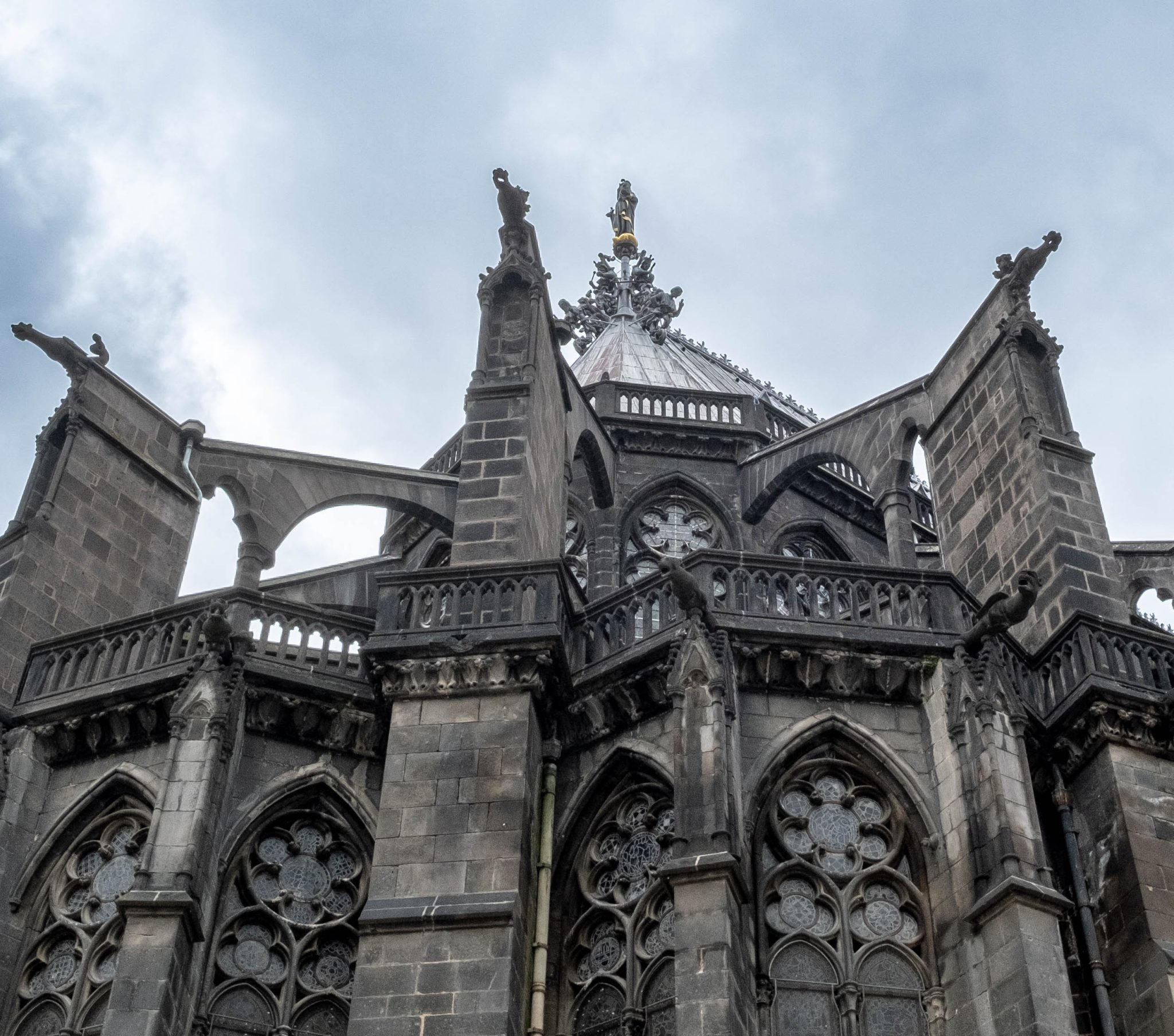 An ancient, dark landmark dominates the skyline of Clermont-Ferrand ...