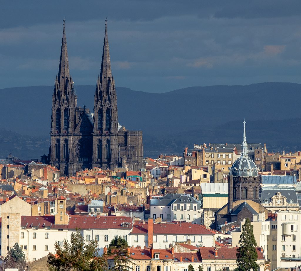 An ancient, dark landmark dominates the skyline of Clermont-Ferrand ...